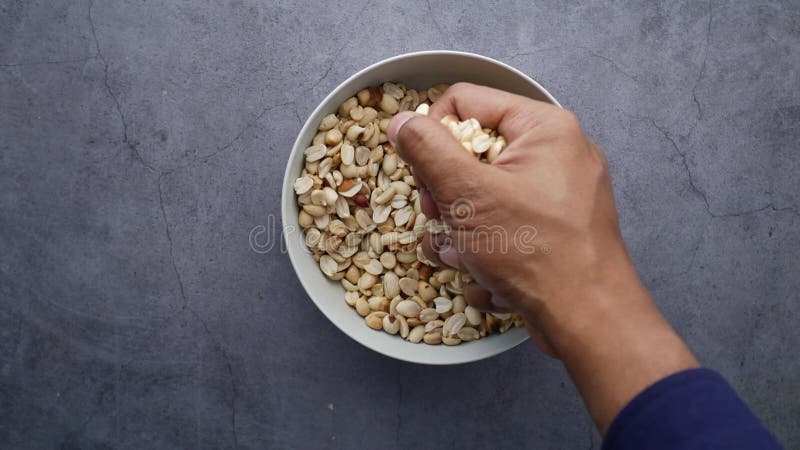 Top View of Hand Pick Peanuts from a Bowl on Table Stock Footage ...