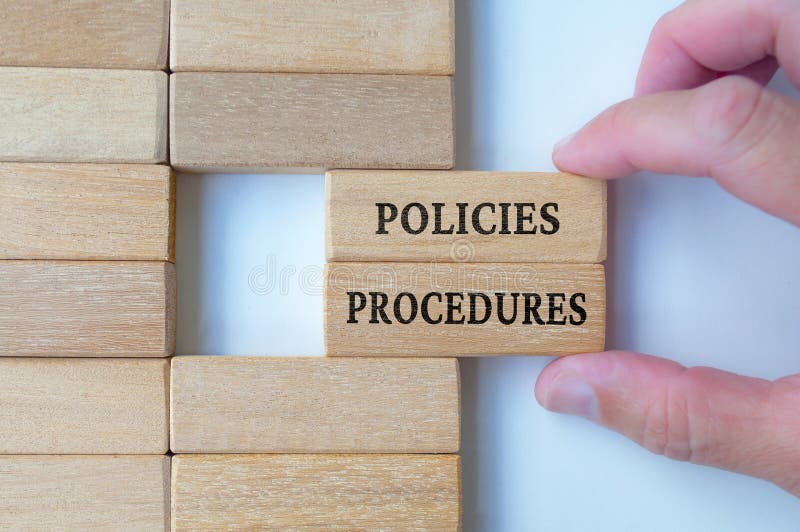 Top View of Hand Pulling Out Wooden Blocks with Text, Policies and Procedures Stock Image ...