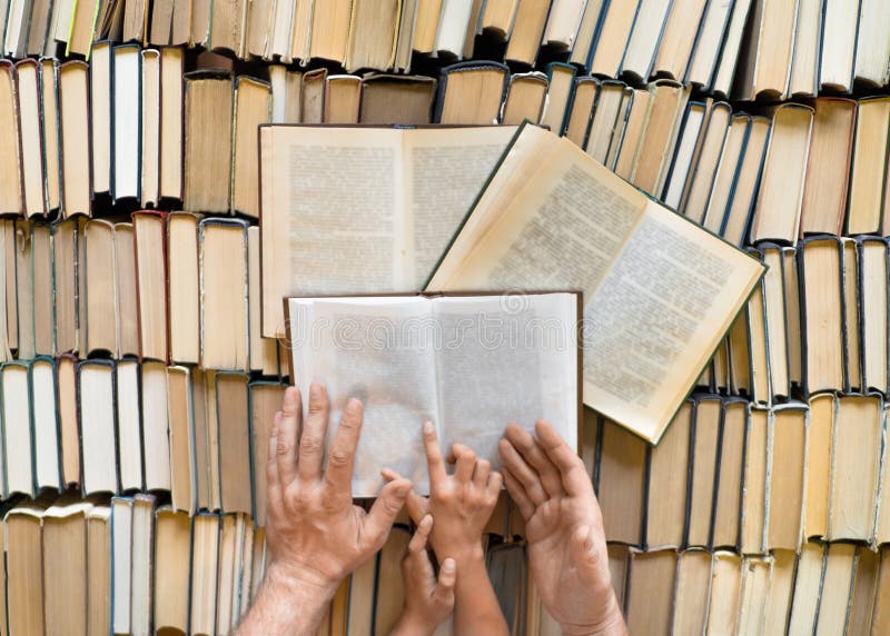 Top View of a Hands of a Father and Kid Over a Lot of Books. Stock ...