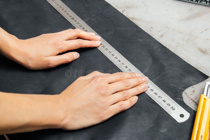 Top View of the Hands of a Leather Craftsman. Holds a Metal Ruler Stock ...