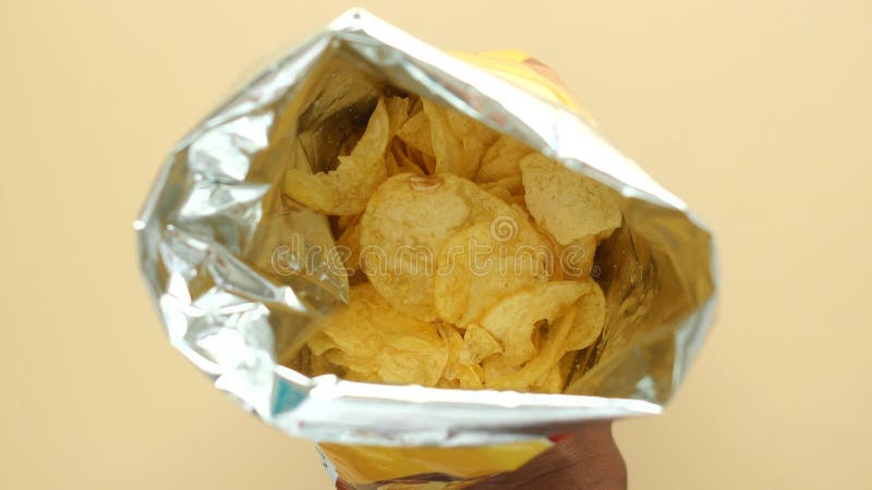 Potato Chips Spilling Form a Packet on Table Stock Video - Video of ...