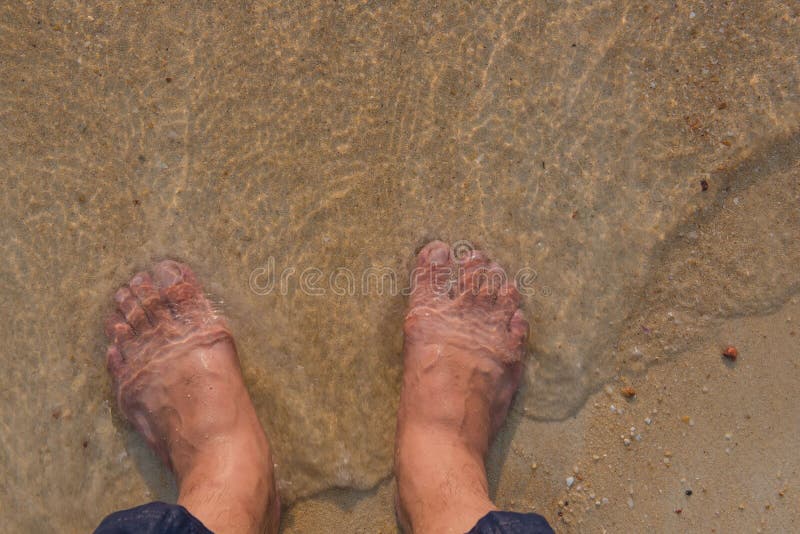 Top View and Human Feet on the Sand and Waves Sea in the Summer Stock ...