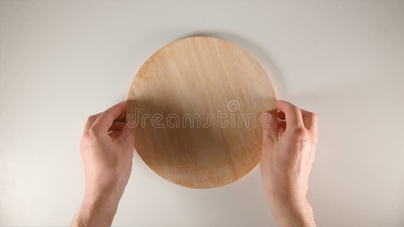 TOP VIEW: Human Hands Puts a Round Cutting Board on a White Table Stock ...