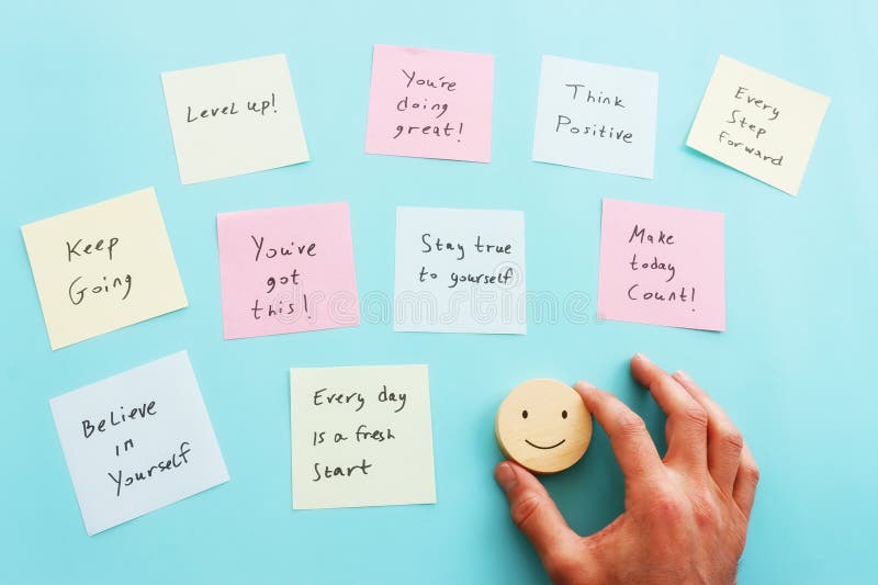 Top View Image of Board with Motivation Notes and Hand Placing Cube ...