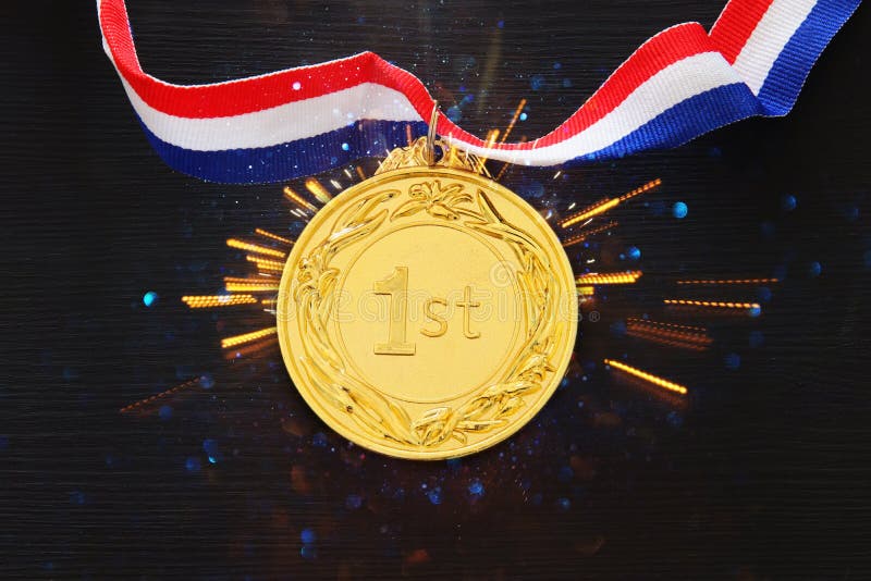 Top View Image of Gold Medal Over Black Background. Glitter Overlay ...