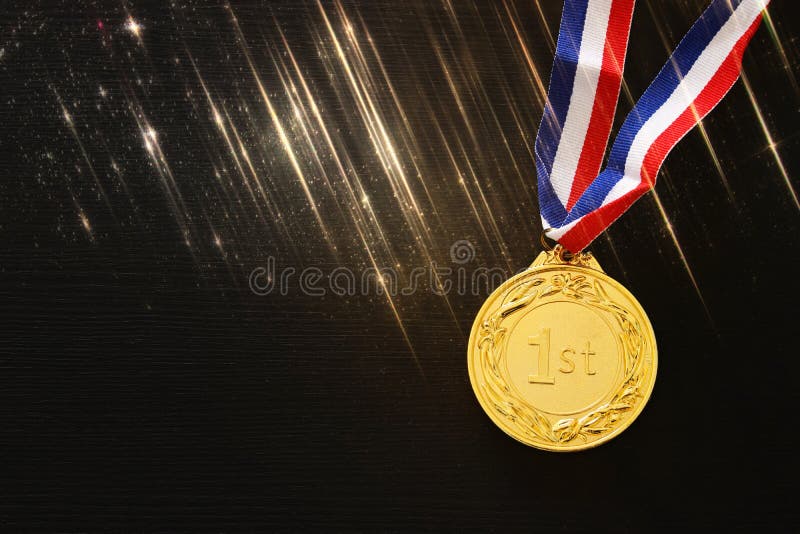 Top View Image of Gold Medal Over Black Background. Glitter Overlay ...