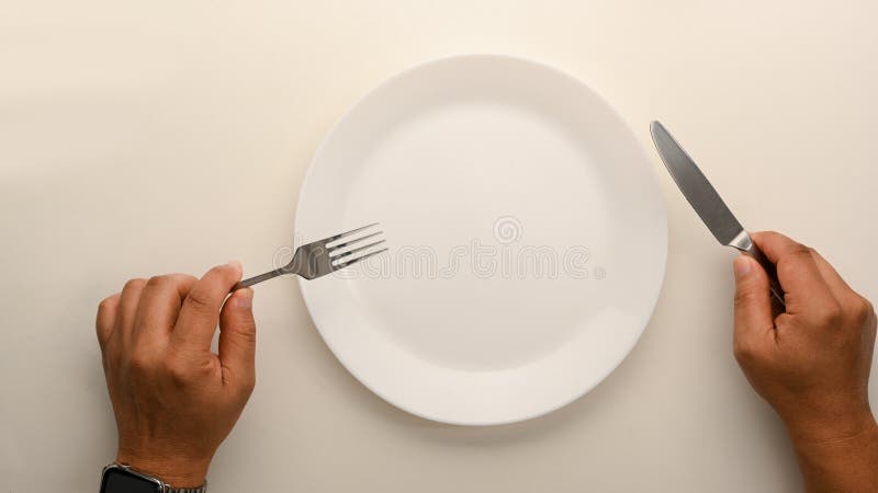 Top View Image of a Man Holding Fork and Knife Over Dining Table Stock ...
