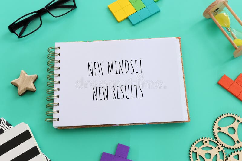 Top View Image of Table with Notes and the Text New Mindset New Results ...