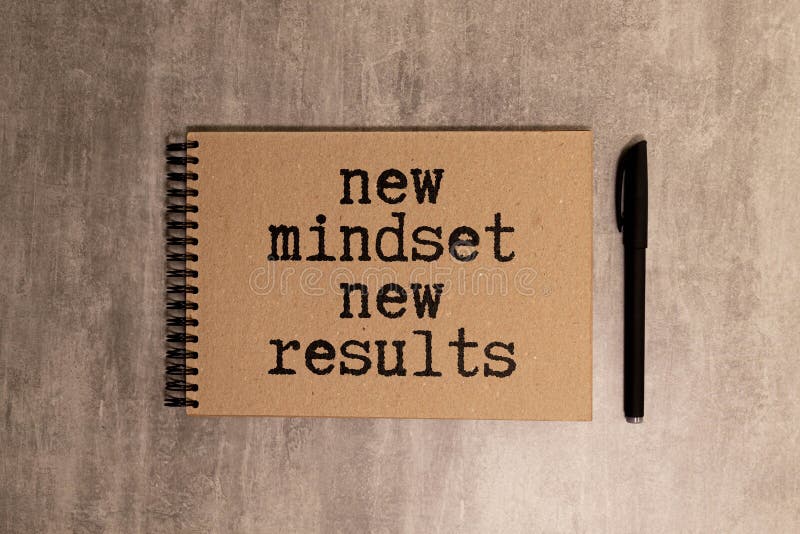 Top View Image of Table with Open Notebook and the Text New Mindset New ...