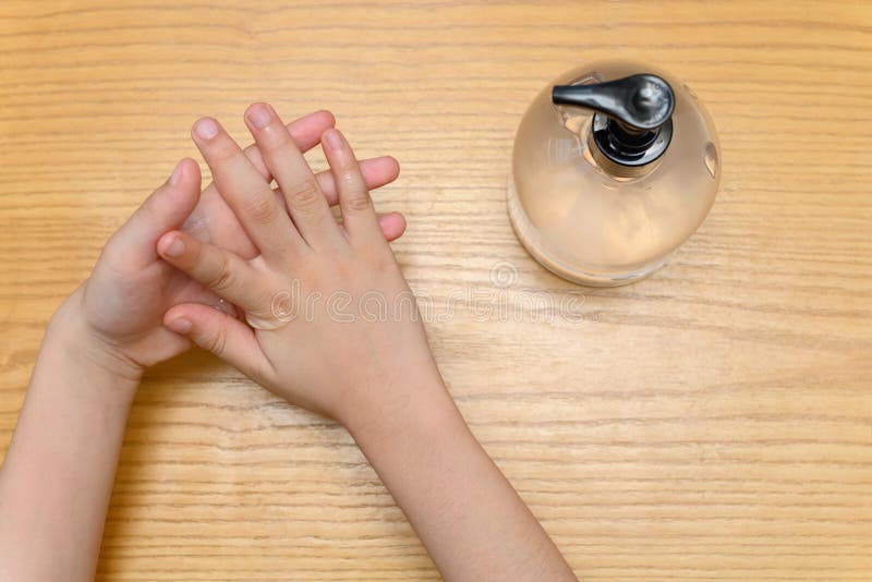 Kid Using Instant Hand Sanitizer To Clean His Hands Stock Image - Image ...