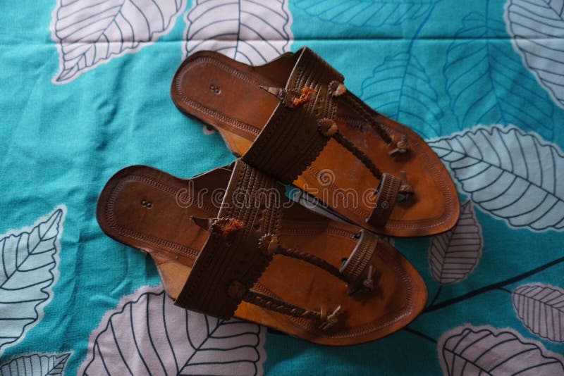 Top View of Kolhapuri Slippers on a Blue Fabric Stock Photo - Image of ...