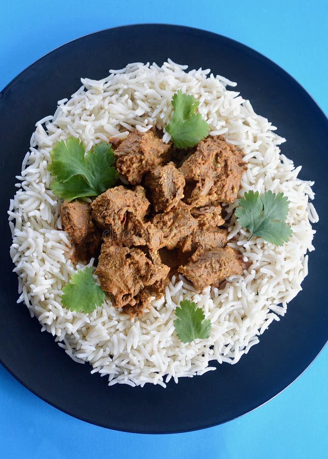 A Top View of Lamb Korma with Basmati Rice and Coriander Leaves Stock ...