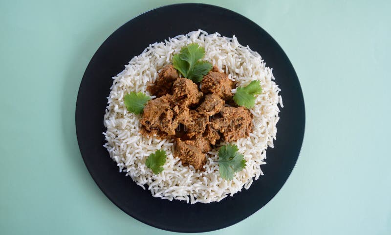 A Top View of Lamb Korma with Basmati Rice and Coriander Leaves Stock ...