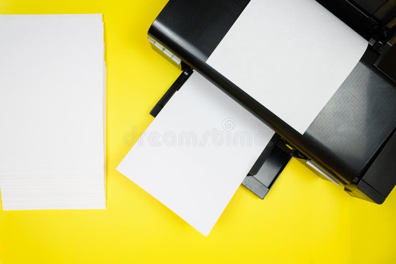 Top View of the Printer and Blank Sheets of Paper on a Yellow ...