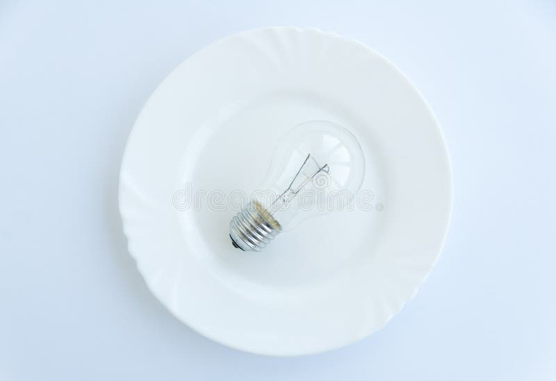 Top View of Light Bulb on a White Plate Isolated on White Background ...