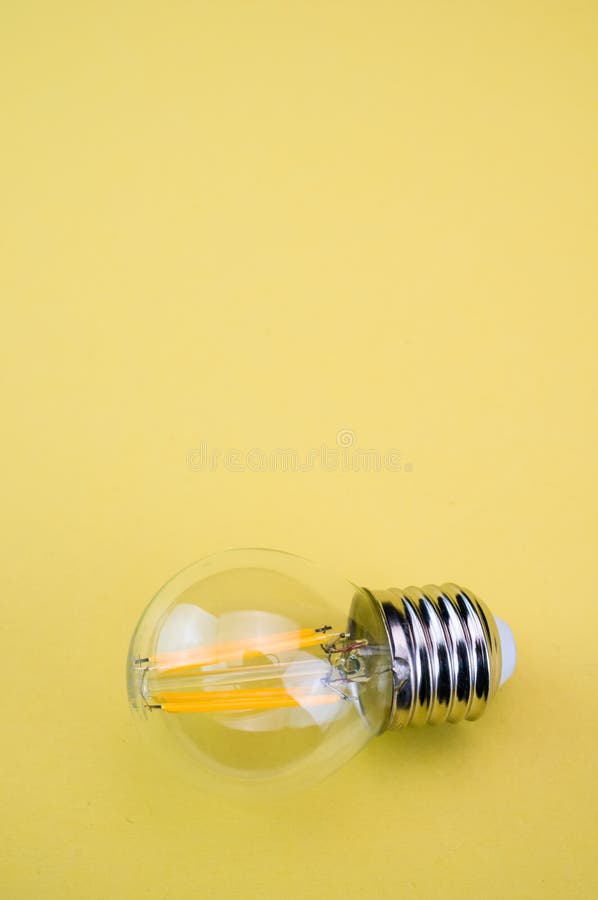 Top View of the Light Bulb on the Yellow Surface Stock Photo - Image of ...