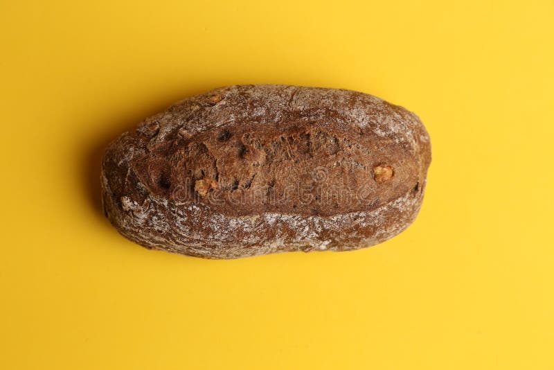 Top View of a Loaf of Dry Brown Bread on a Yellow Surface Stock Photo ...