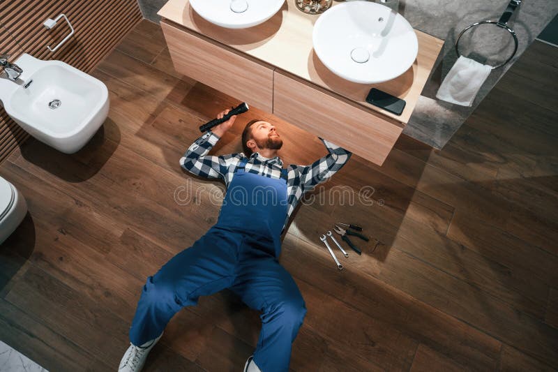 Top View. Lying Down on the Ground, Fixing Water Tap Stock Photo ...