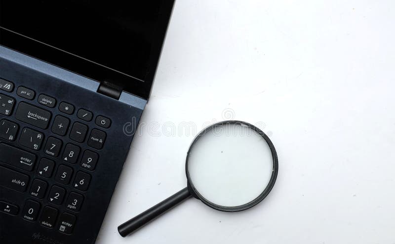 Top View a Magnifying Glass with a Laptop Keyboard on the Office Desk ...