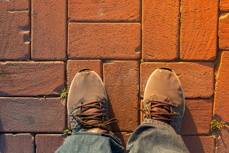 Top View of a Male`s Worn Out Sneakers Standing on a Brick Path Stock ...