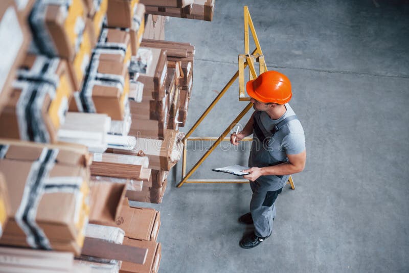 Top View of Male Worker in Warehouse with Notepad in Hands Stock Photo ...