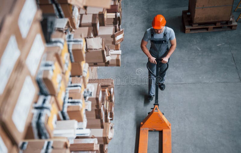 Top View of Male Worker in Warehouse with Pallet Truck Stock Photo ...