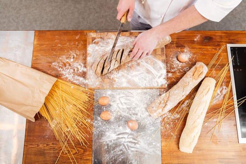 Top View of Man Baker Cutting Bread on Kitchen Stock Photo - Image of ...