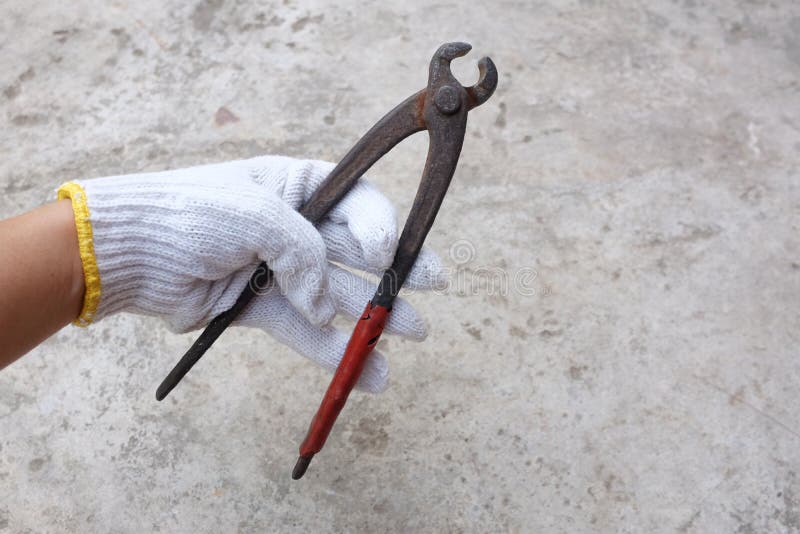 Man Hand Holding Old Wire Cutters on Concrete Background Stock Photo ...