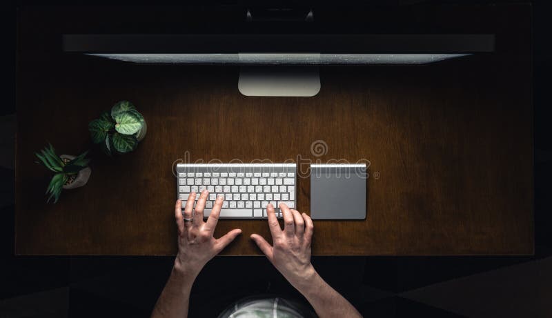 Top View of a Man Working at a Computer in a Dark Room at Night. Stock ...