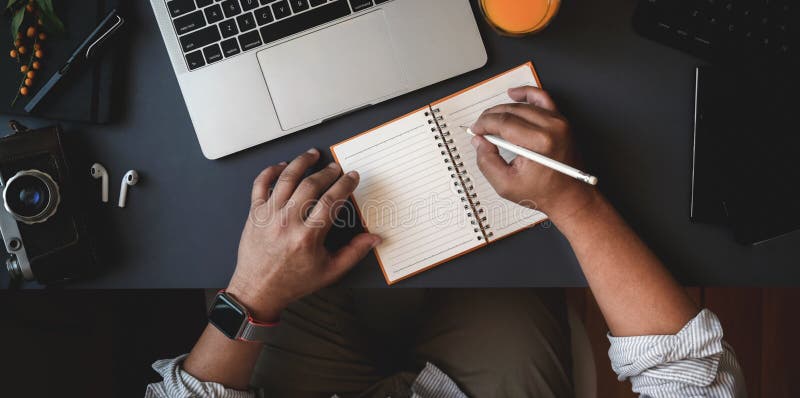 Top View of Man Working on His Project while Writing His Ideas on Note ...