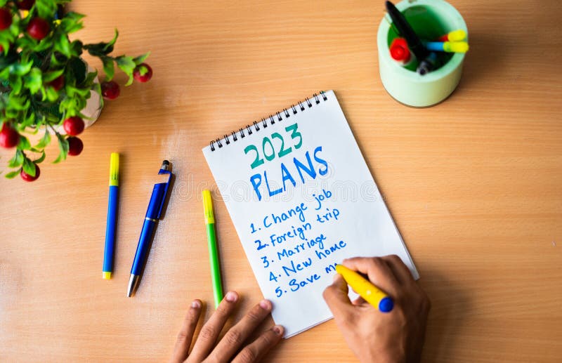 Top View of Man Writing New Year 2023 Plans on Book - Concept of ...