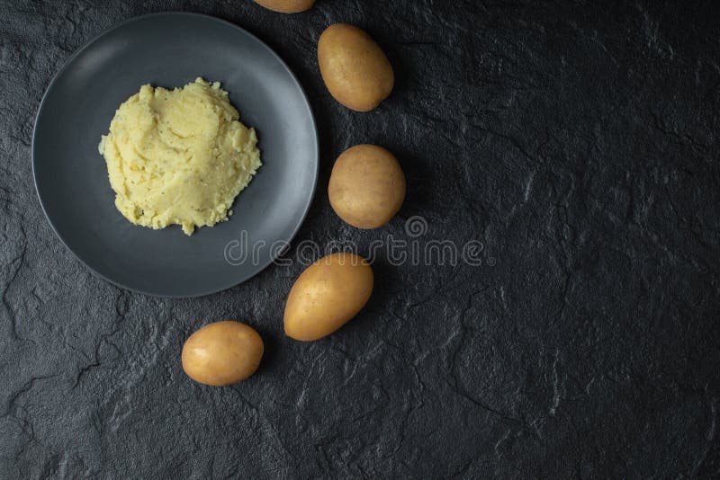 Top View of Mashed Potato on a Plate, and Fresh Potatoes Around it ...