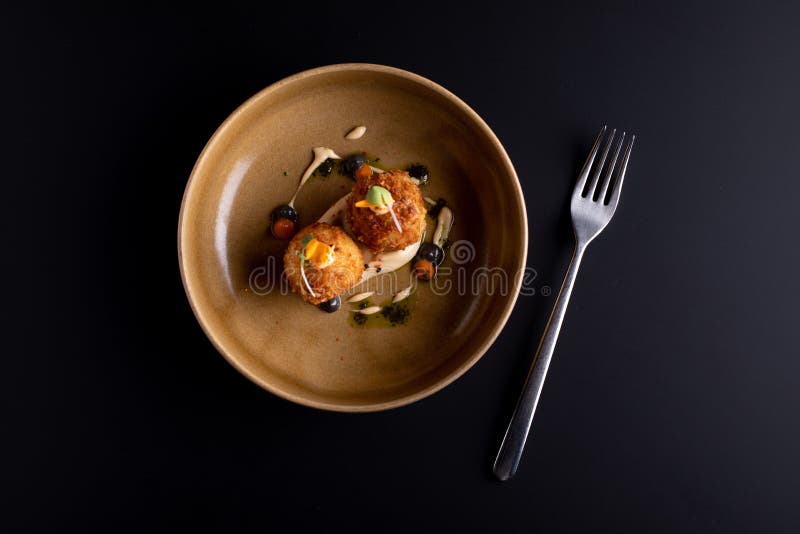 Top View of a Meal in a Brown Plate with Fork on Black Background Stock ...