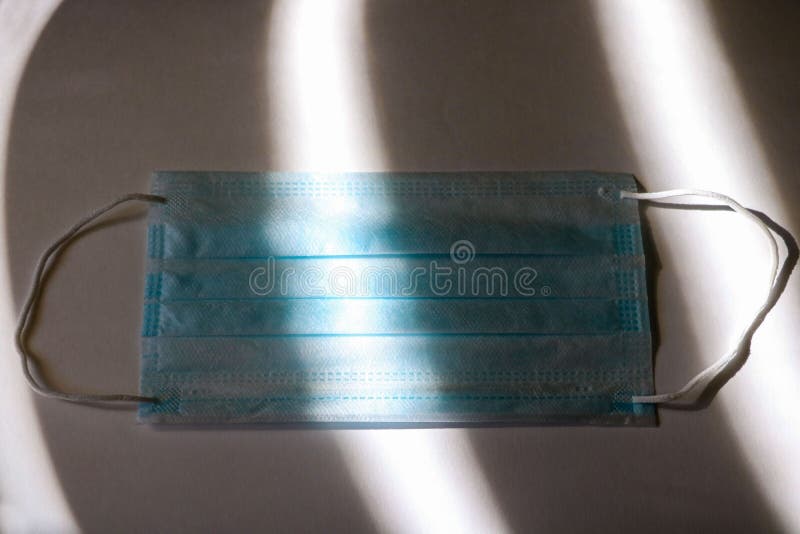 Top View of a Medical Disposable Mask with Sunlight Shadows Stock Photo ...