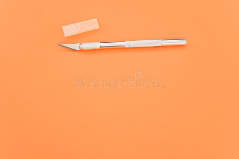 Top View of Metallic Scalpel with Cap Isolated on Orange Background ...