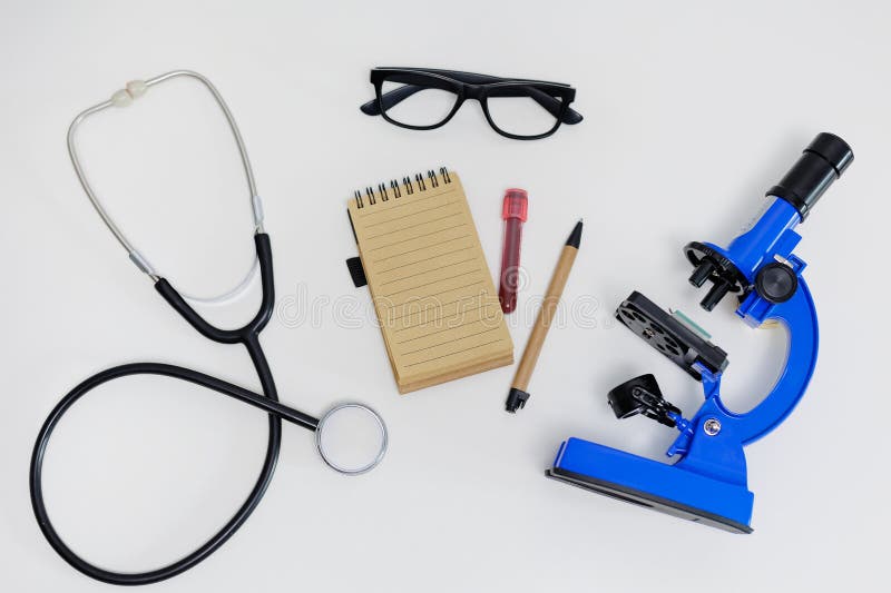 Top View of Microscope, Stethoscope, Eyeglasses and Notebook with Pen ...