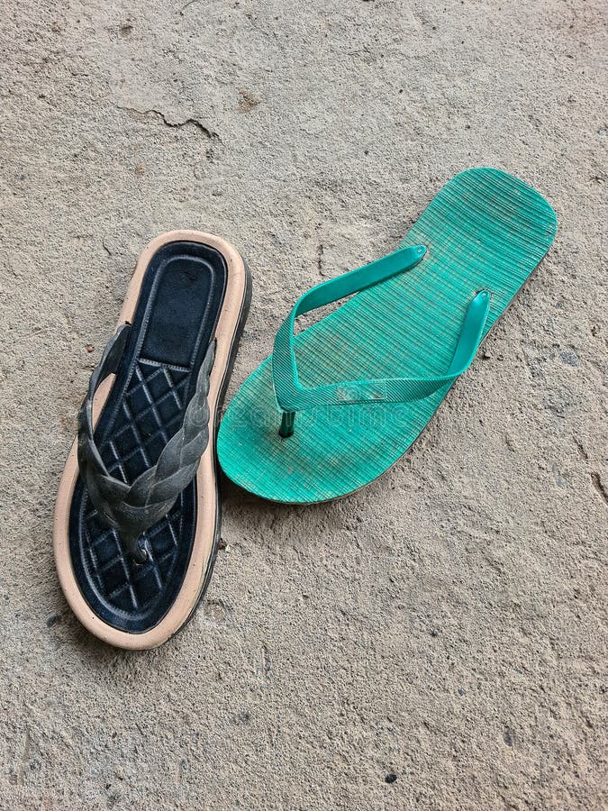 Top View of Mismatched Flip Flops on a Concrete Background Outdoors ...