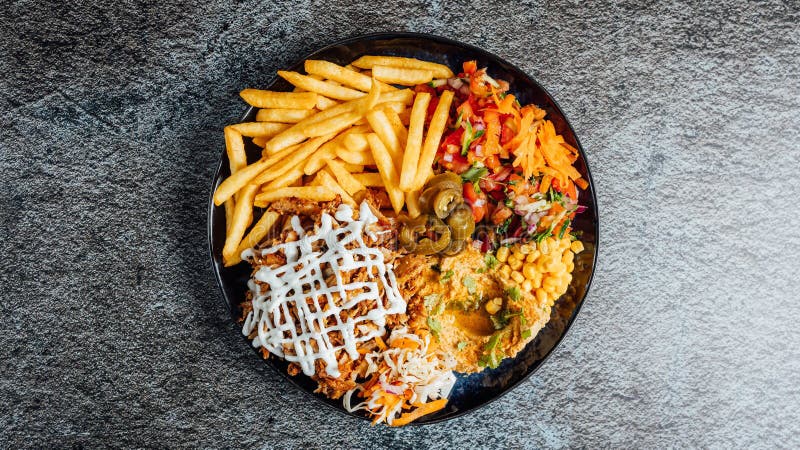 Top View of a Mixed Dish with Fries, Chicken, and Veggies Stock Photo ...
