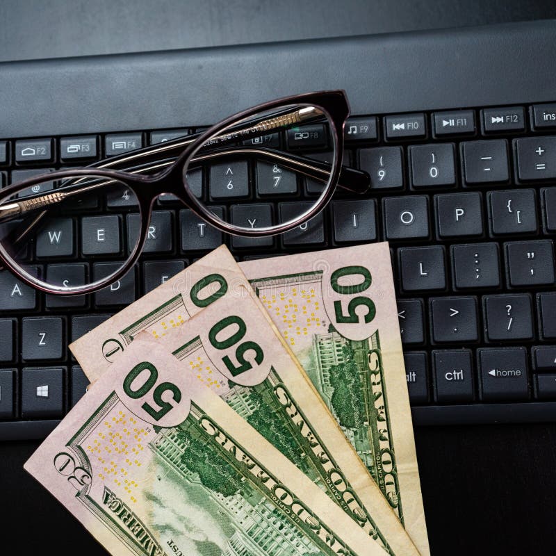 Top View of Money on Keyboard. Dollars Money and Glasses on Keyboard ...