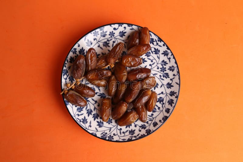 Top View of Moroccan Dates on a Plate Isolated on Orange Background ...