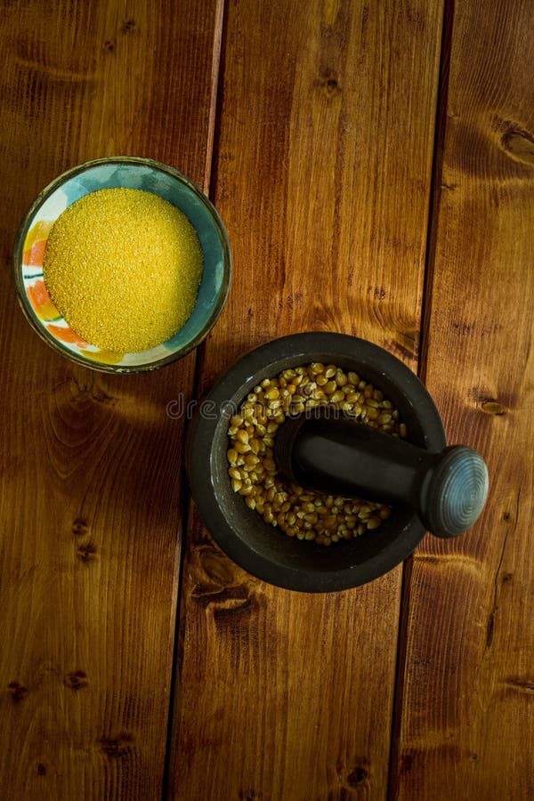 Top View of Mortar and Pestle with Corn Kernels in it on a Wooden Table ...