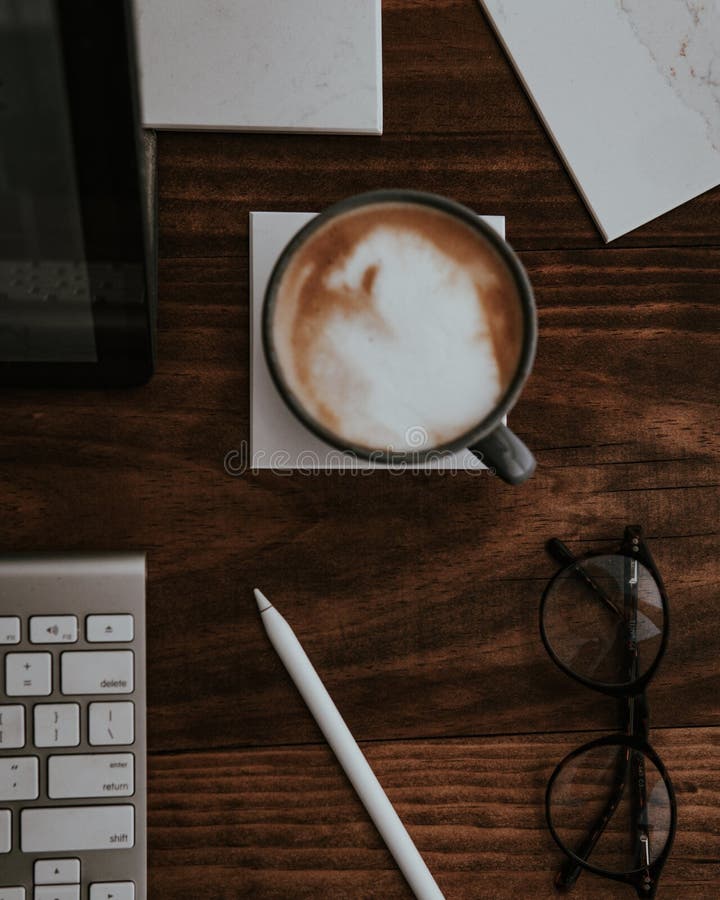 Top View of Mug of Nescafe with Computer and Pen on a Table Stock Photo ...