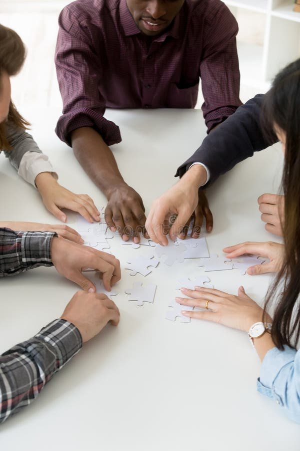 Multiethnic Workers Assembling Jigsaw Puzzle while Teambuilding Stock ...