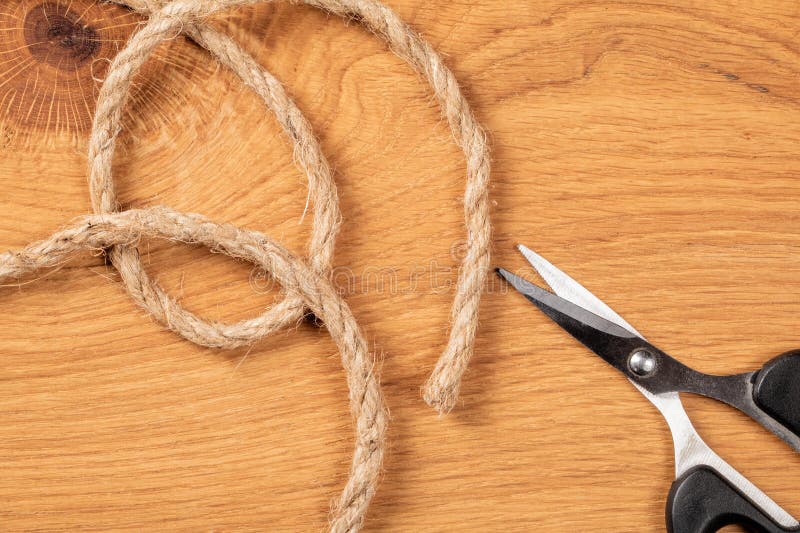 Coil of Rough Rope and Scissors on Wooden Background, Top View Stock ...