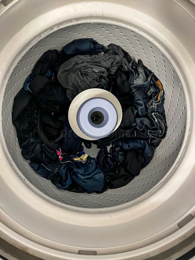 Top View of an Open Laundry Washing Machine with Dark Colored Cloths ...