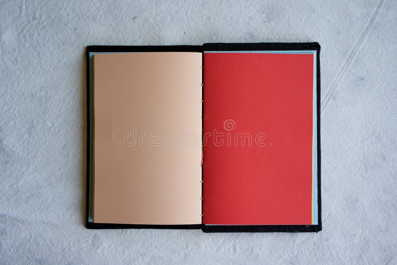 Top View of an Open Notebook with Blank Cream and Red Sheets Placed on ...