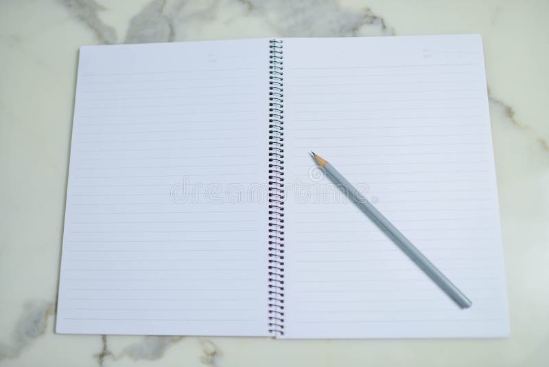 Top View of Open Spiral Blank Notebook with Pencil on White Desk ... Top View of Open Spiral Blank Notebook with Pencil on White Desk ...