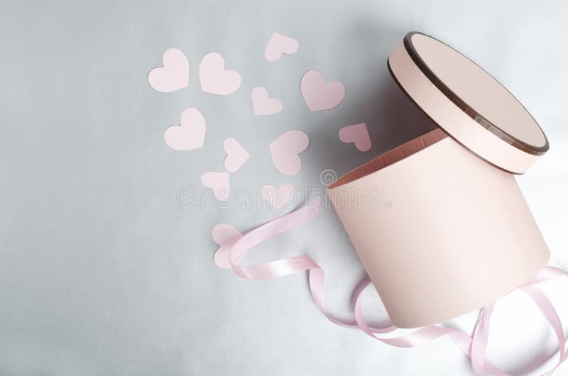 Top View of Opened Pink Round Box and Little Paper Pink Hearts on the ...