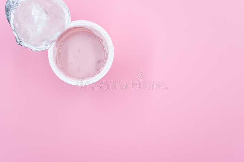Top View of an Opened Plastic Container of Fruit Yogurt on a Pink ...
