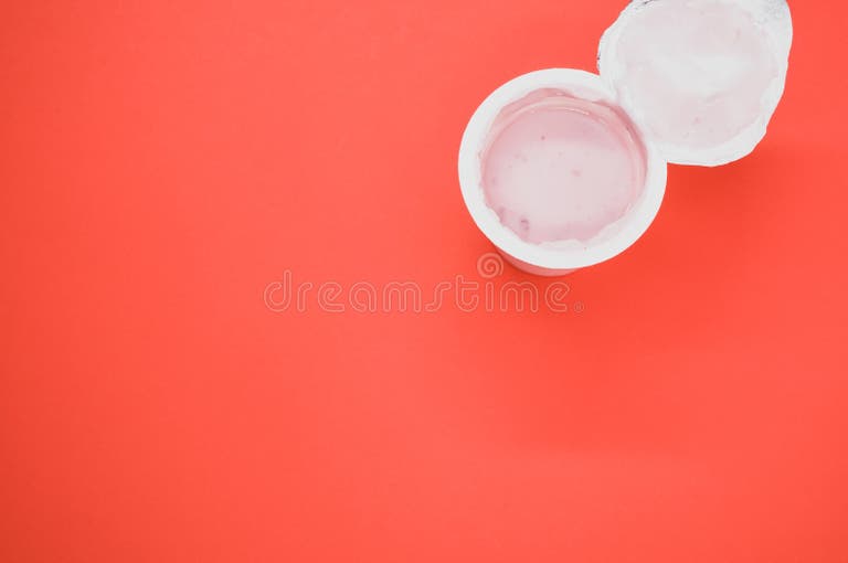 Top View of an Opened Plastic Container of Fruit Yogurt, on a Red ...